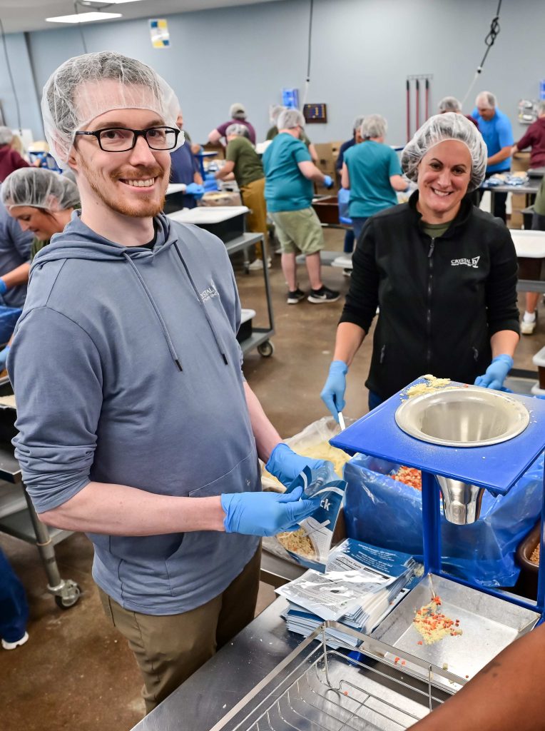 Crystal D team packs meals, feeding 100 children for a year